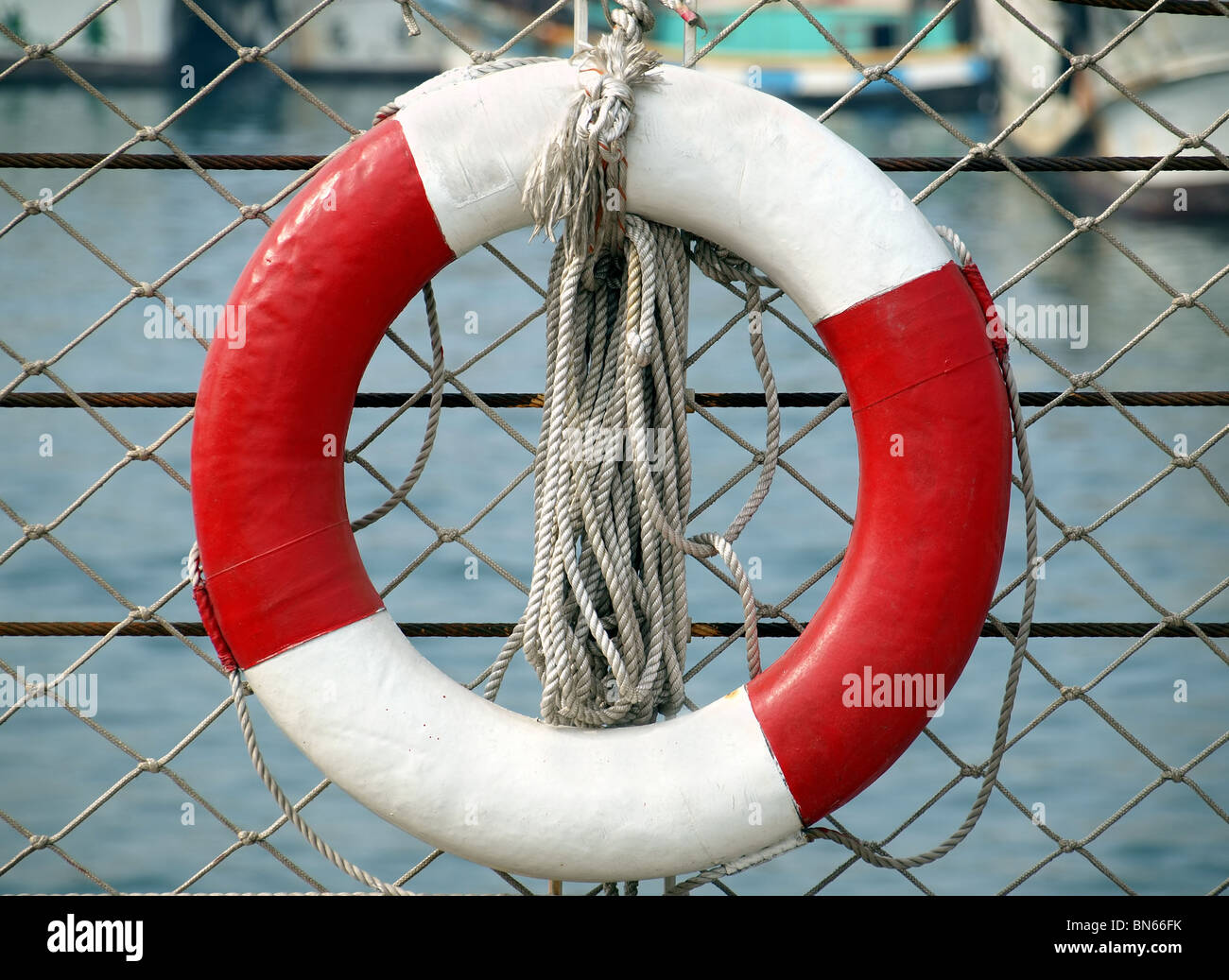 A foam core red and white life ring with a strong rope Stock Photo - Alamy