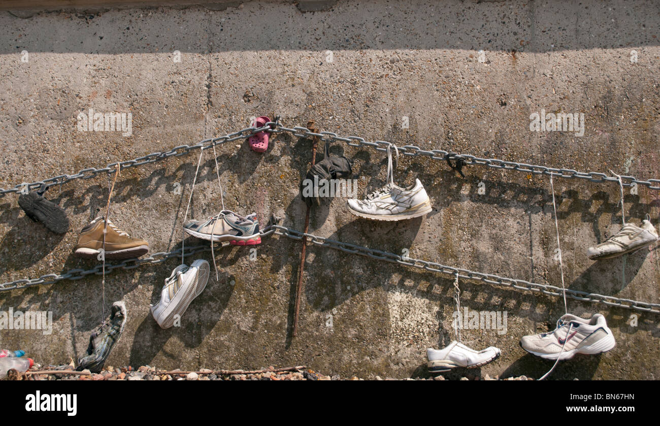 Old running shoes hanging on the anchor chain Stock Photo - Alamy