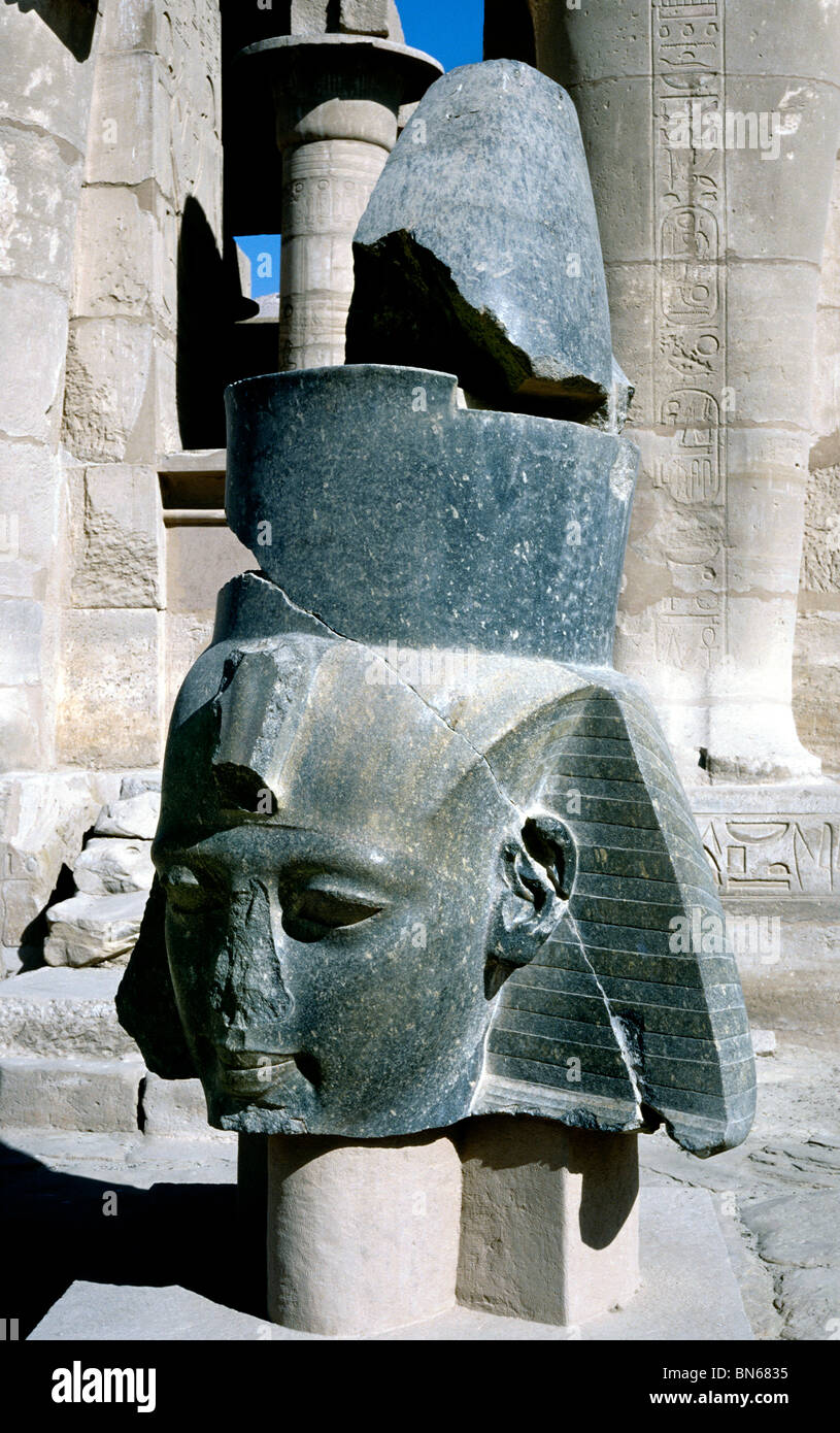 Granite head of Pharaoh Ramesses II at the feet of the Osirid statues ...