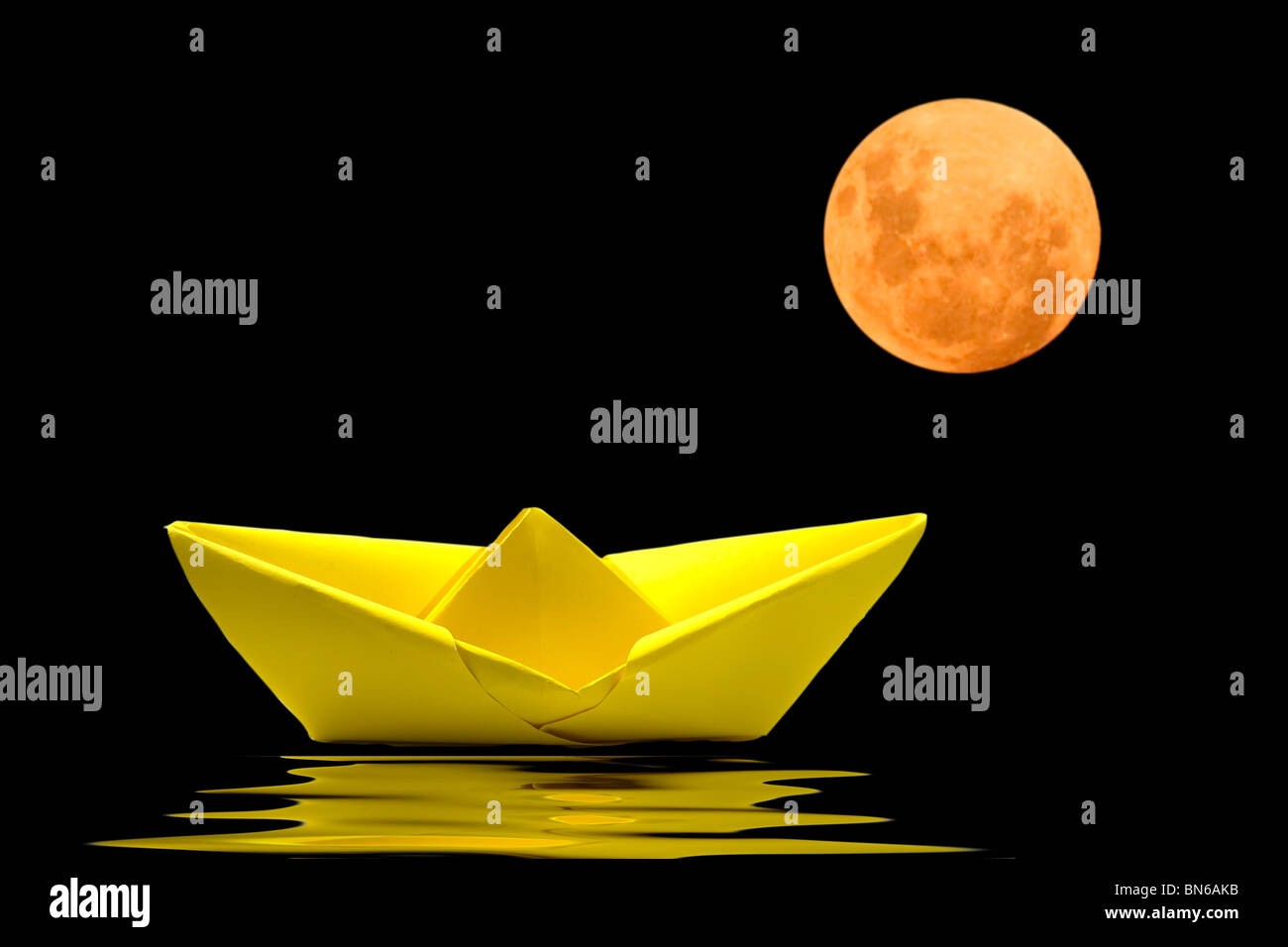 Yellow paper boat on water with blurred moon behind Stock Photo - Alamy