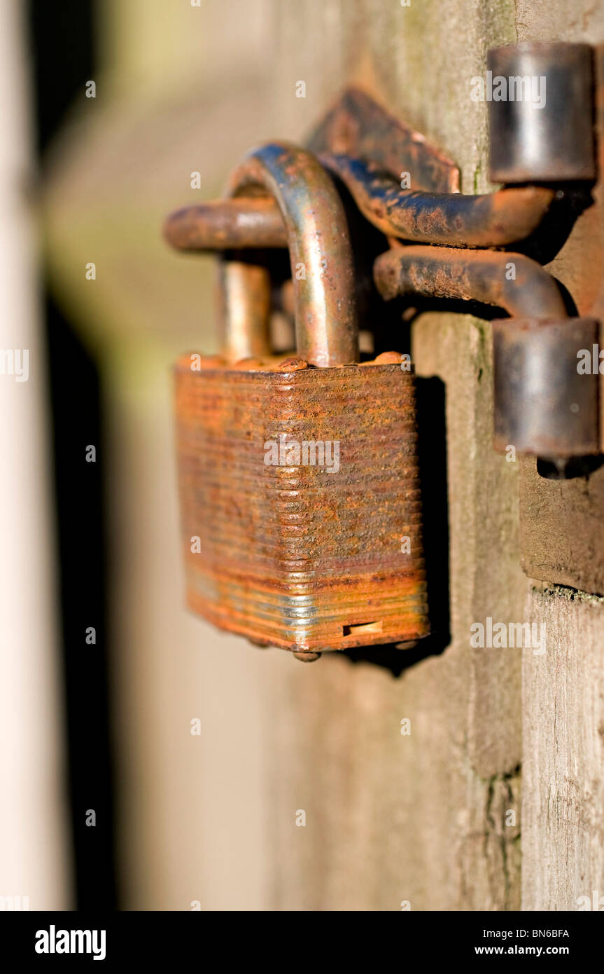 a rusted padlock on a gate Stock Photo - Alamy