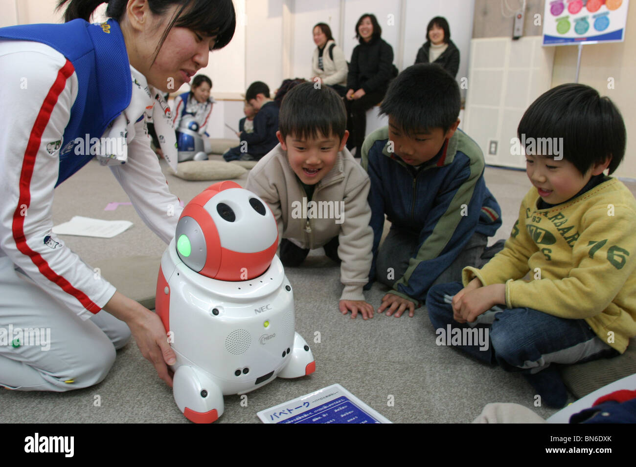 Children play with PaPeRo- a childcare robot, at World Expo 2005, Aichi ...