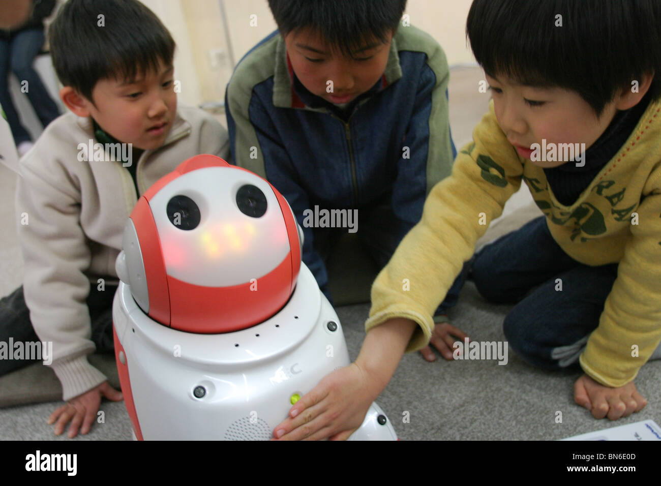 Children play with PaPeRo- a childcare robot, at World Expo 2005, Aichi ...