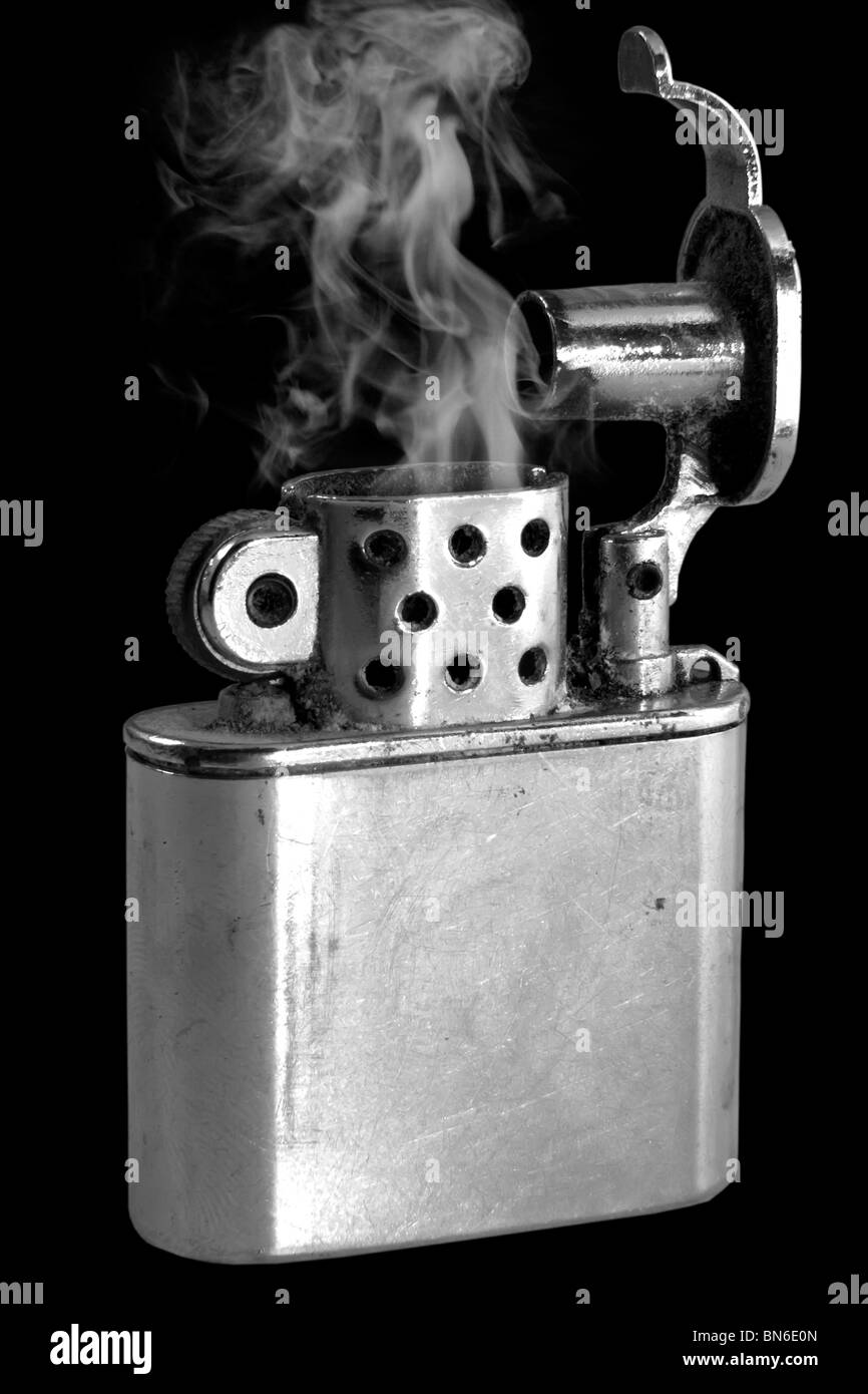 Smoking lighter over black background Stock Photo - Alamy