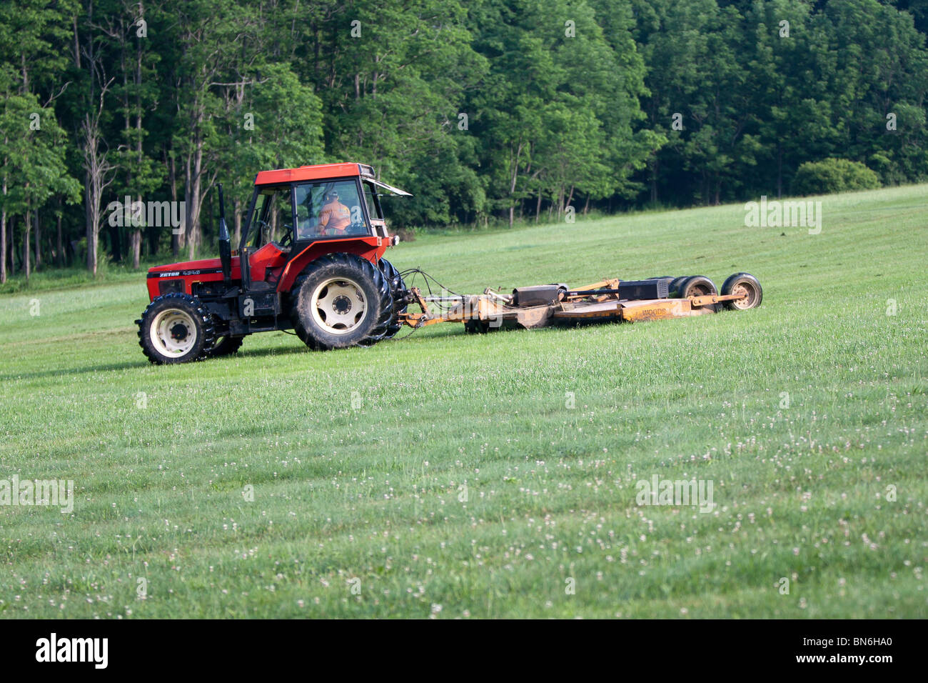 Tractor being used to mow a field Stock Photo - Alamy