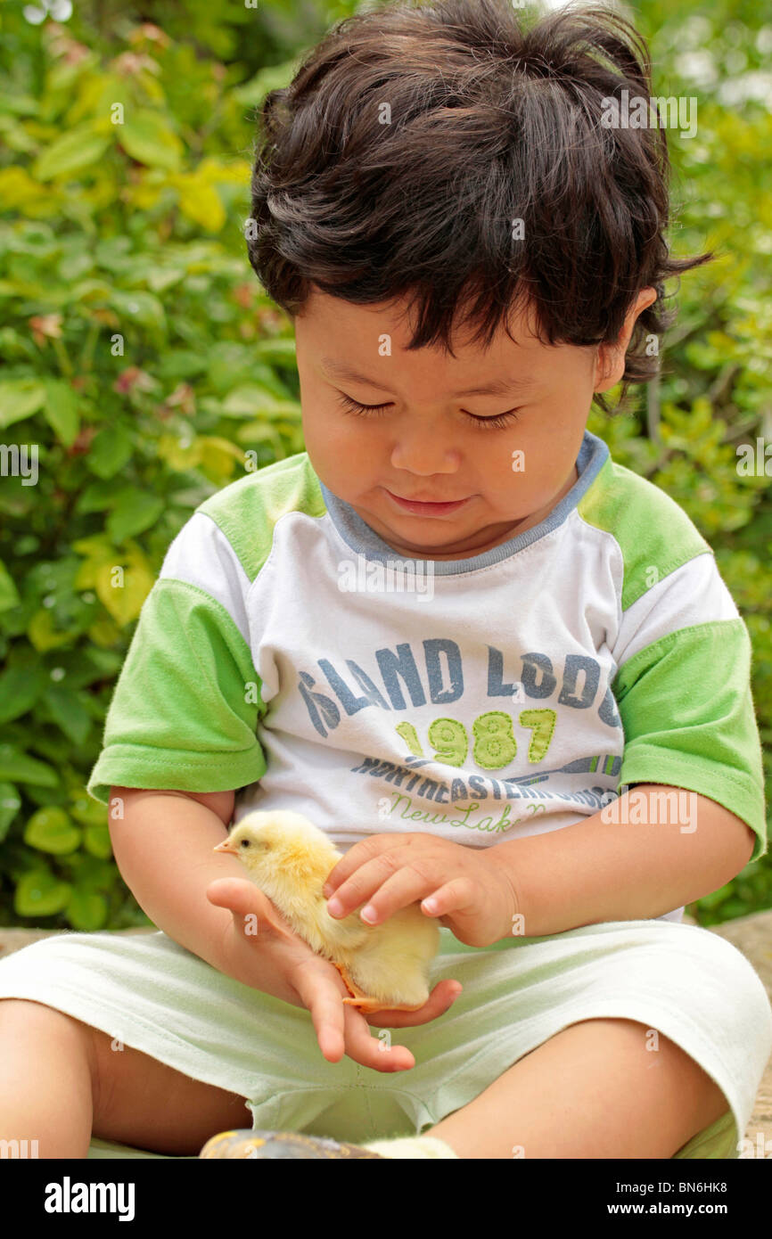 Kid and chick Stock Photo - Alamy