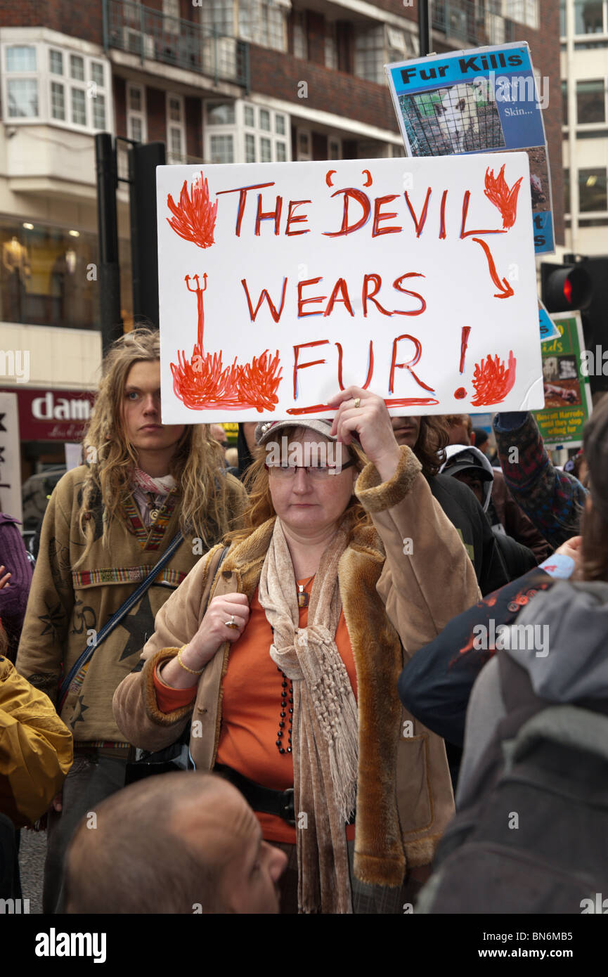 National Anti-Fur March and Rally - Woman holds large poster 'The Devil ...