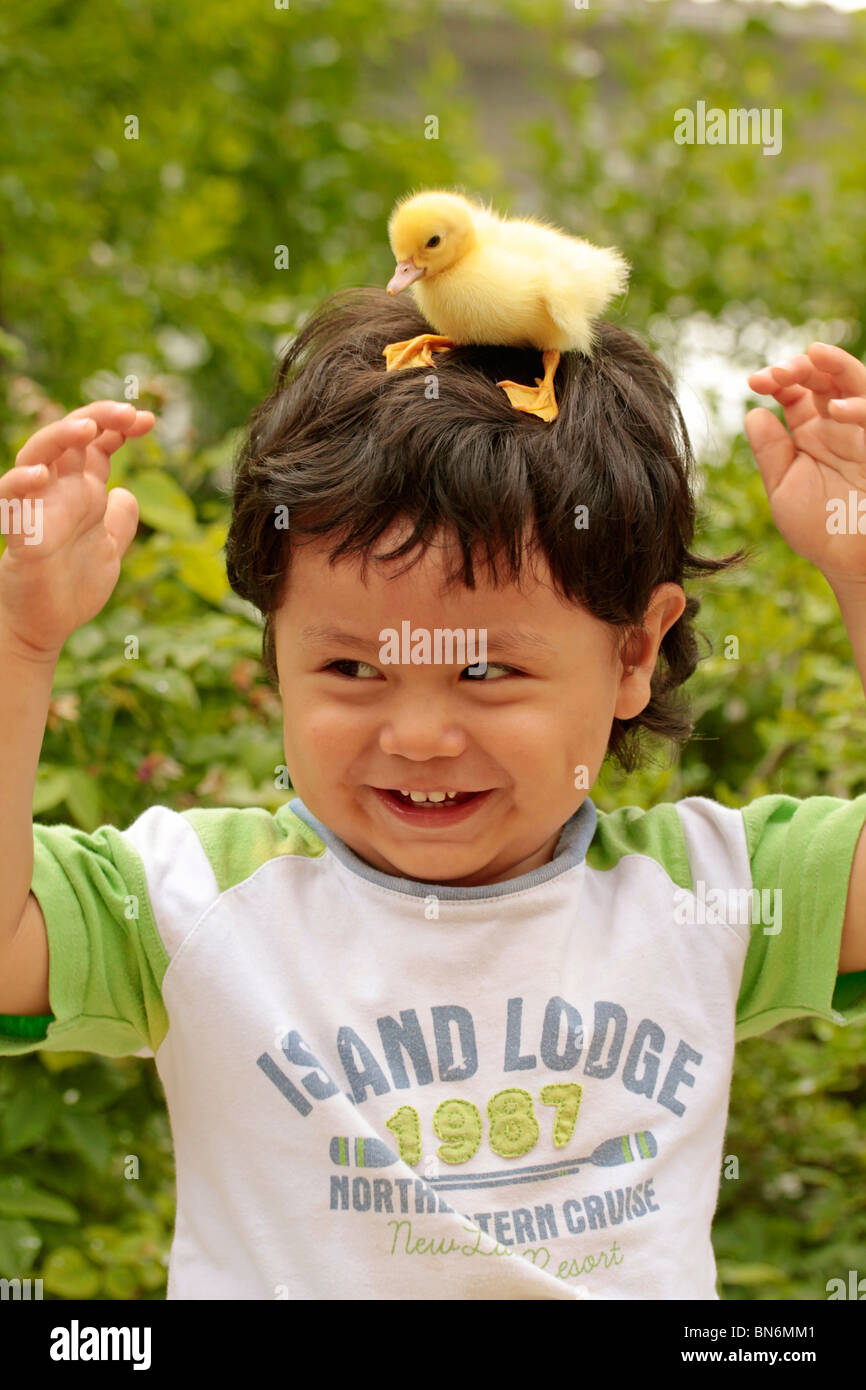 Kid and duckling Stock Photo - Alamy
