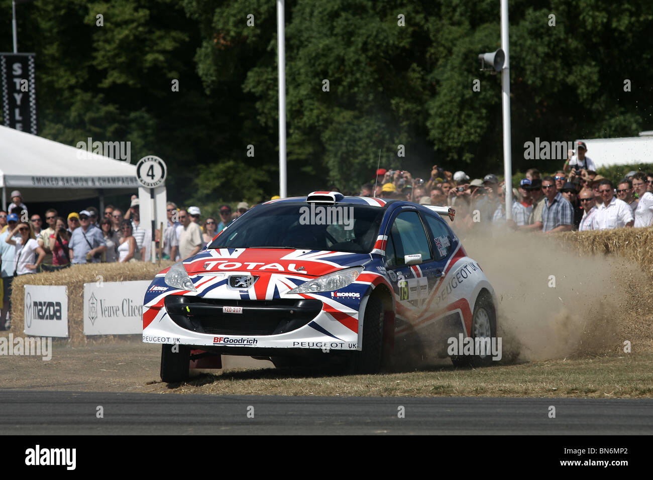 Kris Meeke powers his Peugeot 207 S2000 IRC rally car up the hill at ...