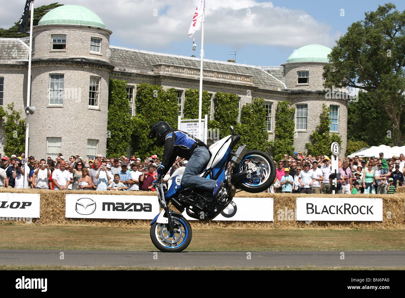 BMW stunt rider performs in front of Goodwood House at the 2010 ...
