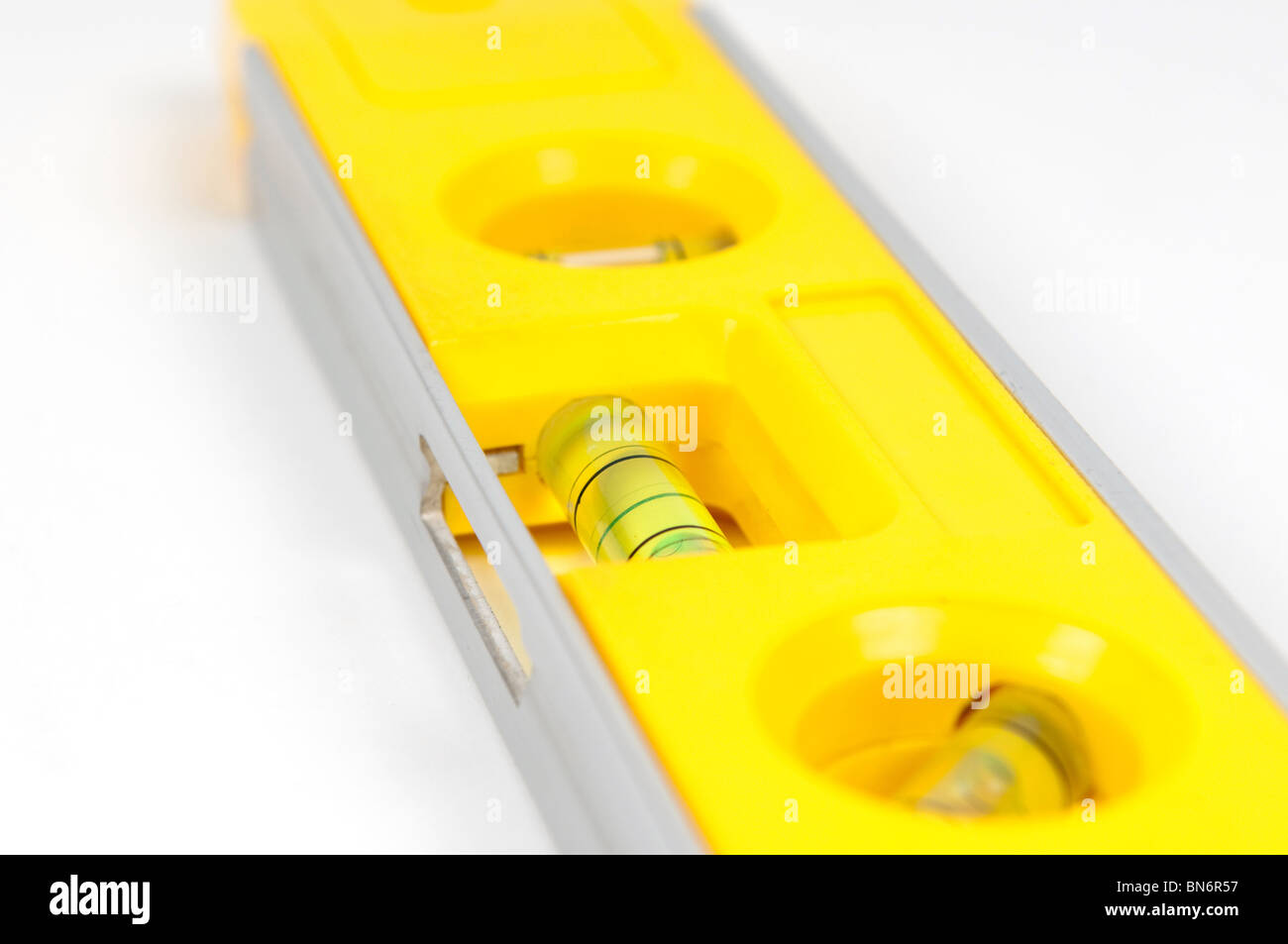 Yellow spirit level isolated on a white background Stock Photo - Alamy