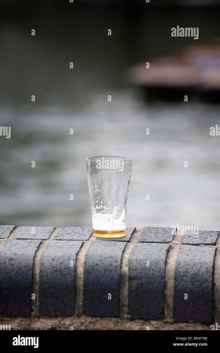 Almost empty pint glass of beer on wall at the Millpond Cambridge ...
