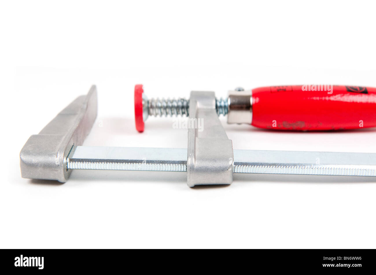 Metal vice with red handle on white background Stock Photo - Alamy