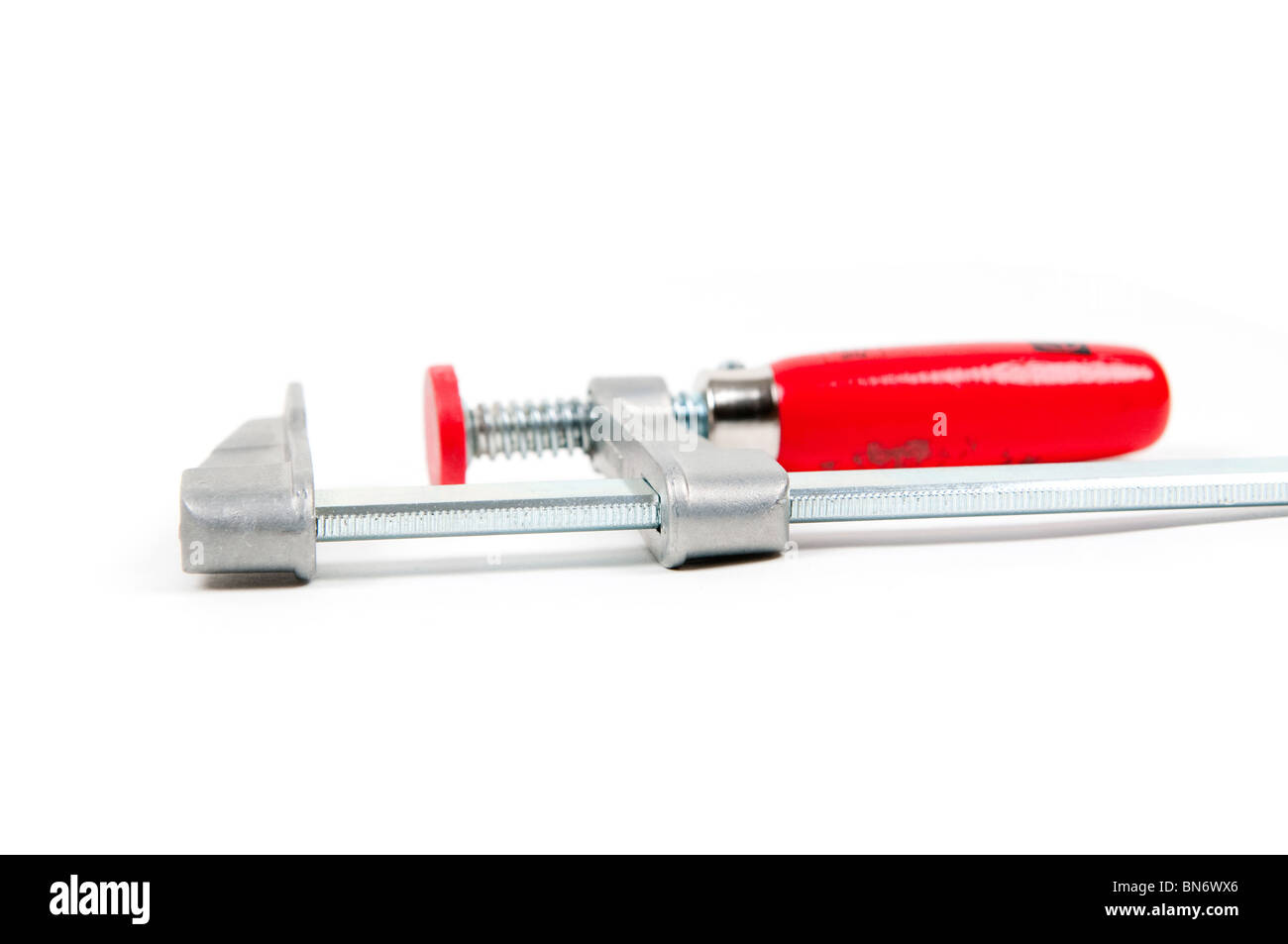 Metal vice with red handle on white background Stock Photo - Alamy