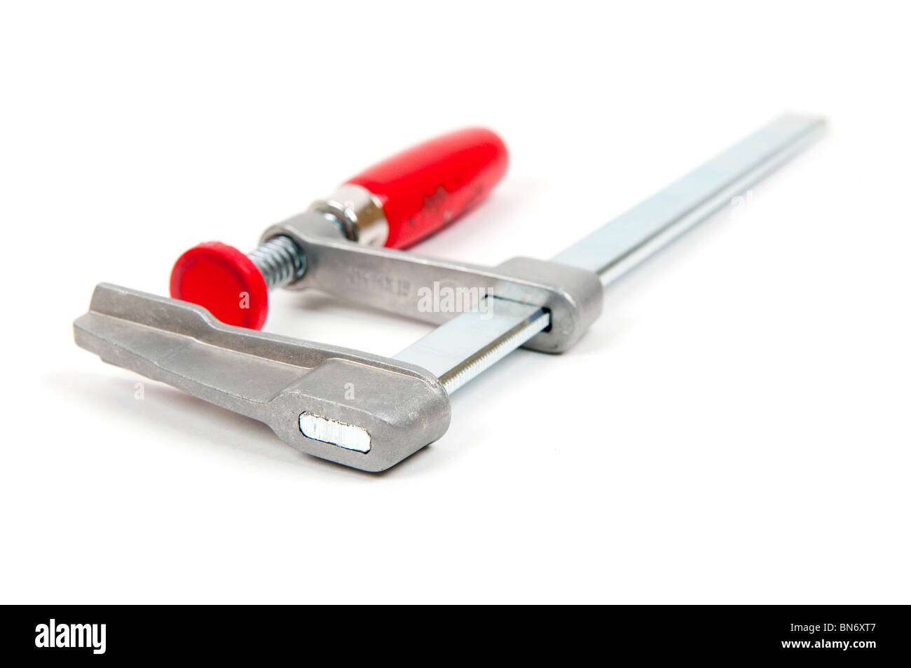 Metal vice with red handle on white background Stock Photo - Alamy