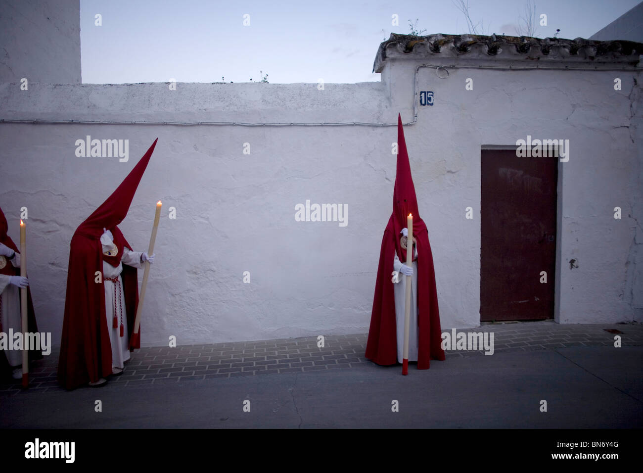 Penitents walk in a street during Easter Holy Week celebrations in ...