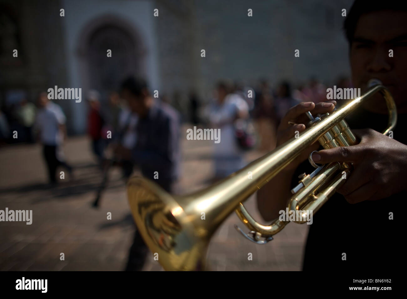 A musician plays a trumpet during holy week celebrations in Oaxaca ...