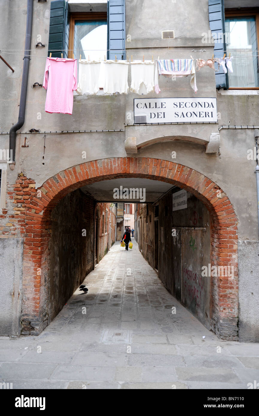 Alleyway in Venice Italy with washing line and person in distance ...