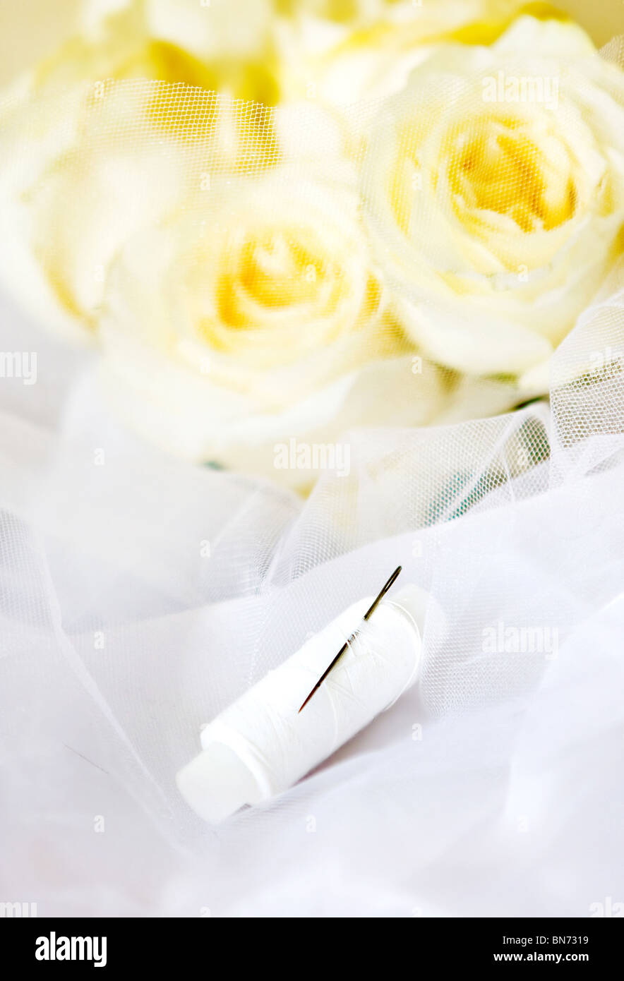 thread bobbin and white rose on textile background Stock Photo - Alamy