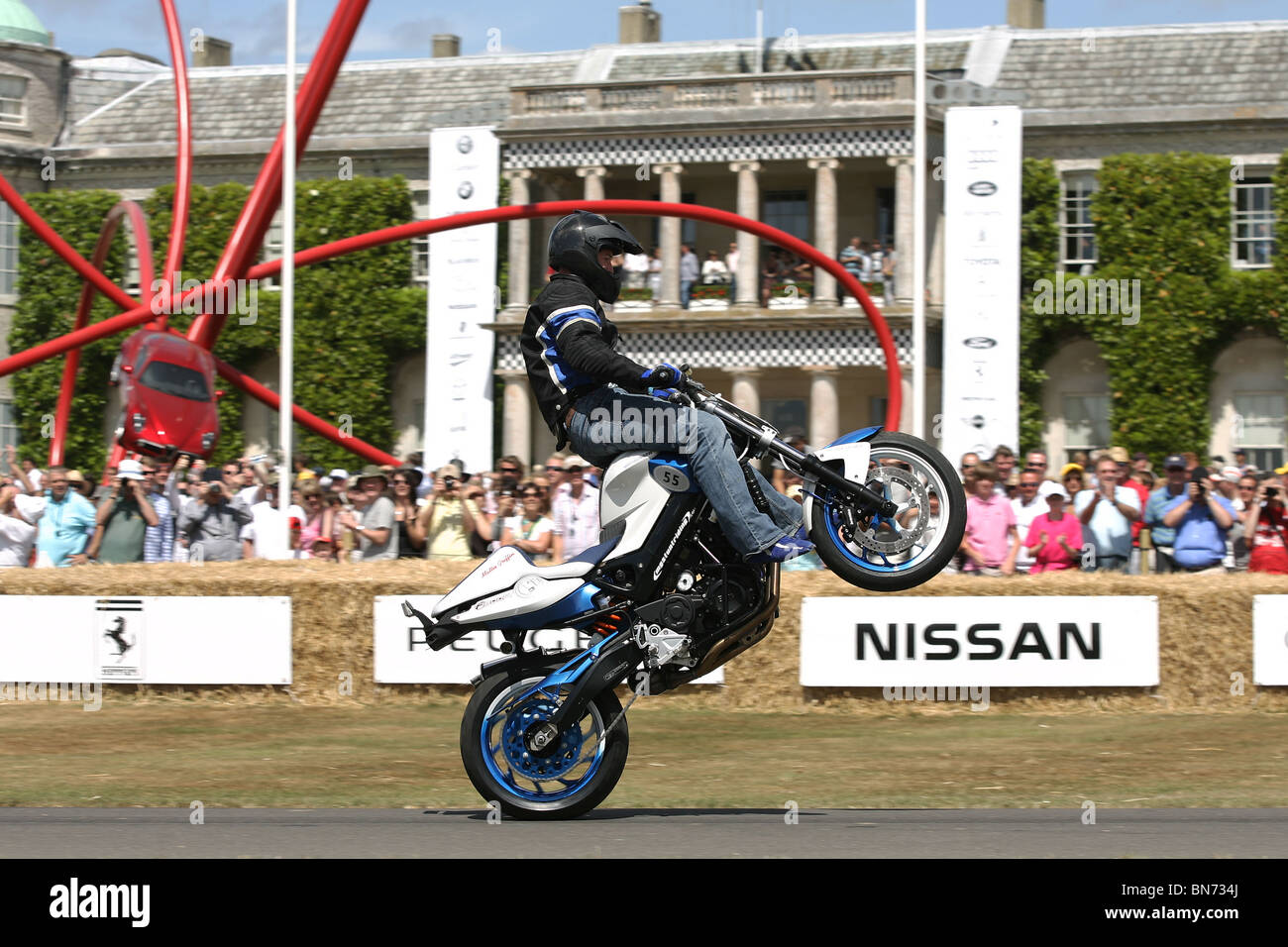 BMW stunt rider performs in front of Goodwood House at the 2010 ...