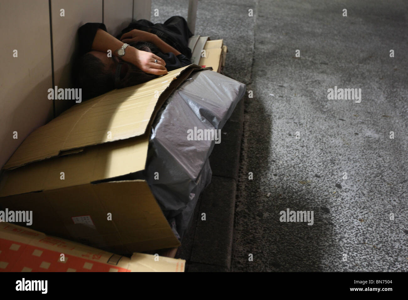 Homeless Men Sleeping Rough In Cardboard Boxes On The Streets Of Tokyo