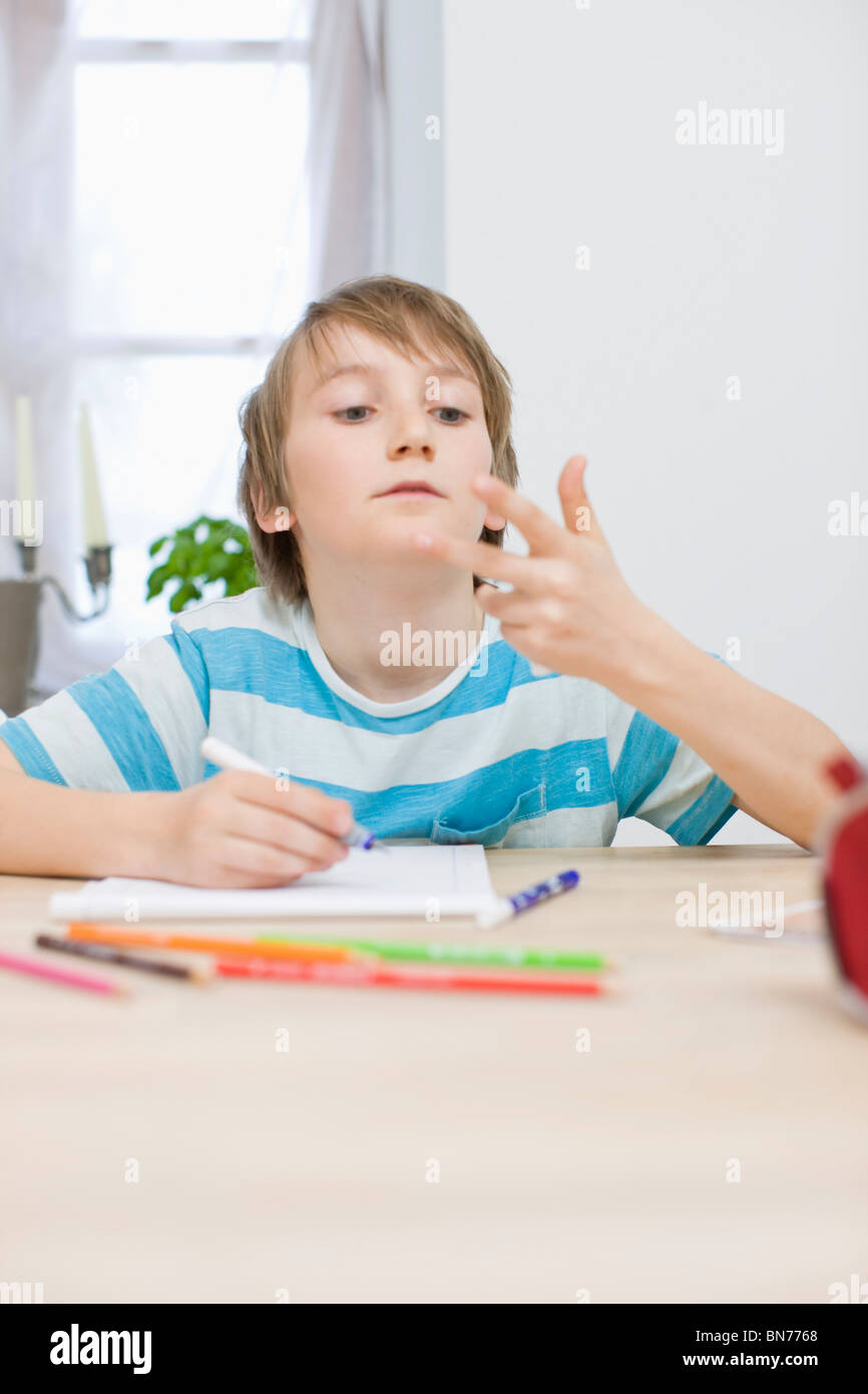 Boy doing his homework Stock Photo - Alamy