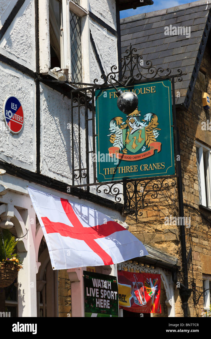 The Three Cranes public house sign on a wrought iron bracket, in the ...