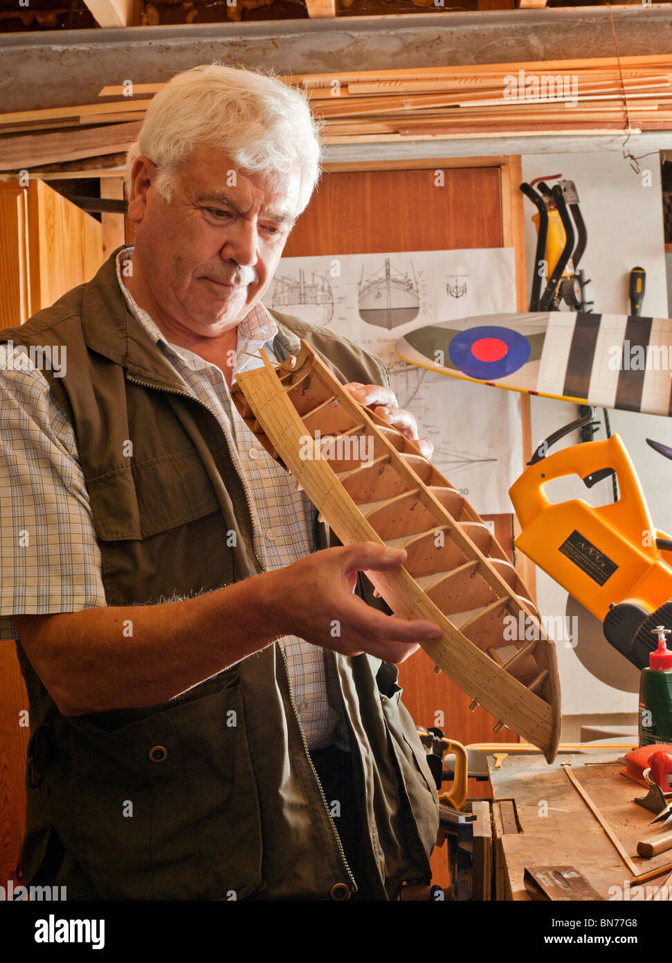 Retired man making wooden model boat Stock Photo - Alamy