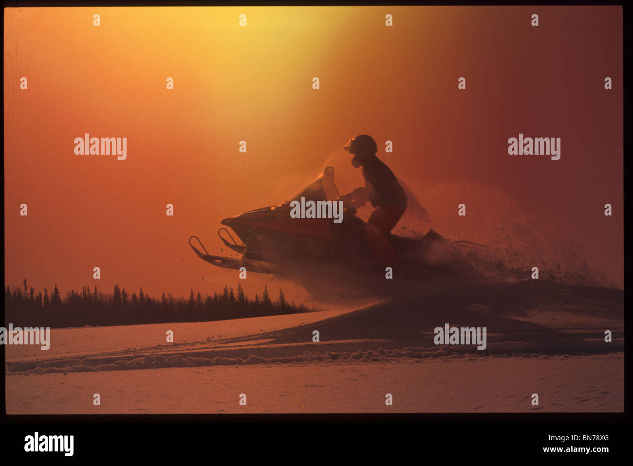 Snowmobile Jumping Sunset Composite winter scenic Stock Photo - Alamy