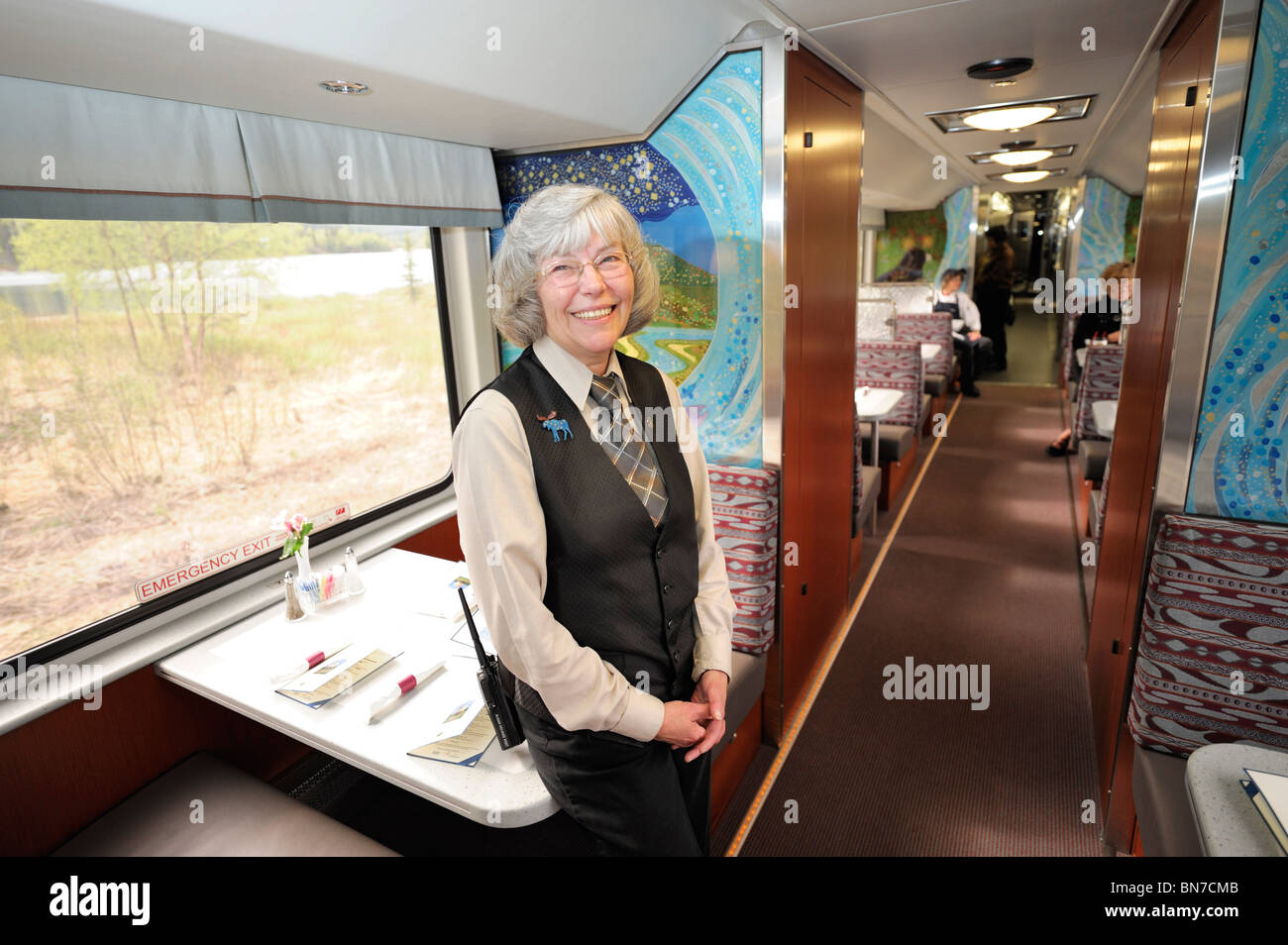 Alaska Railroad GoldStar First-Class service employee poses onboard the ...