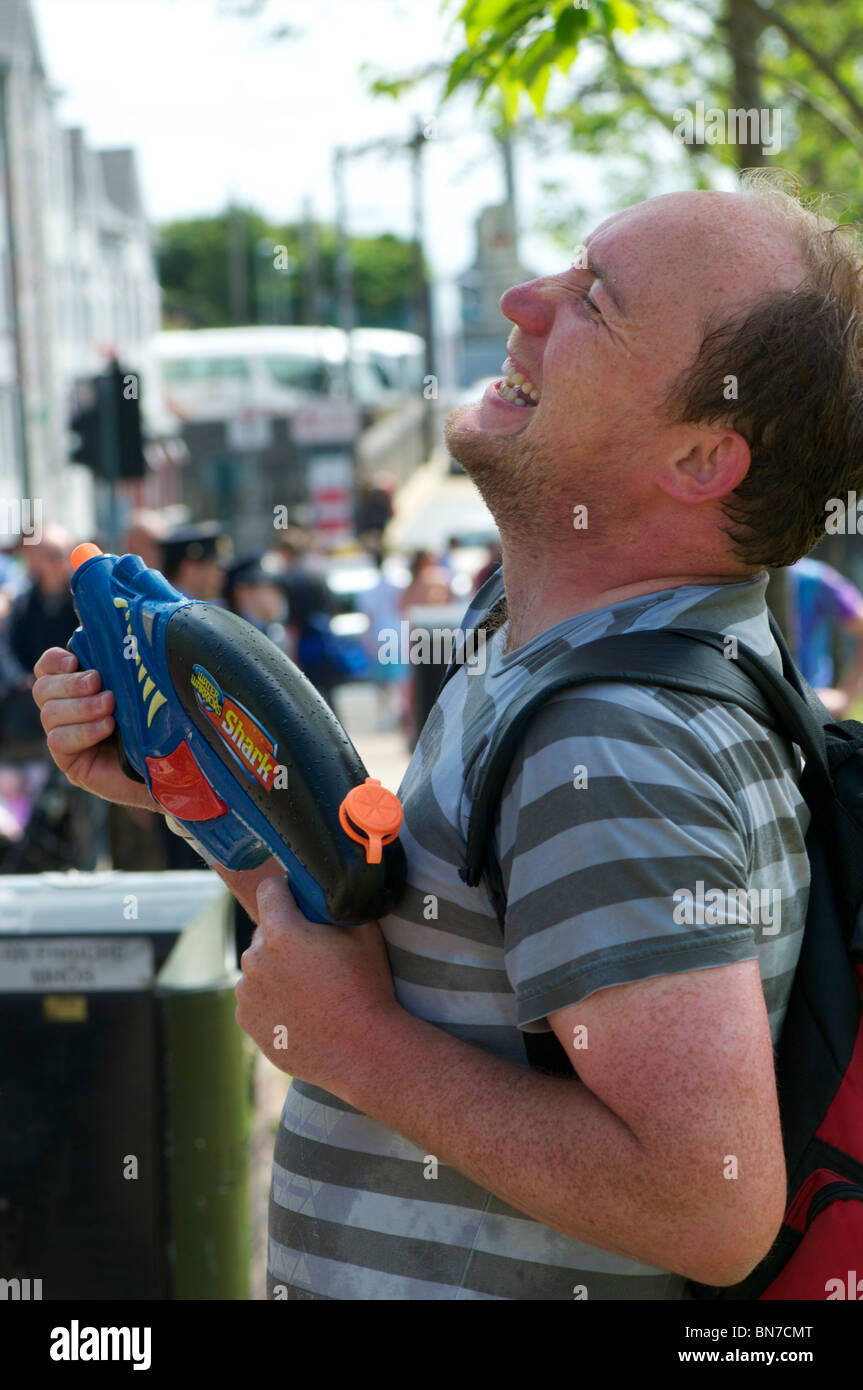 Man with water gun Stock Photo - Alamy