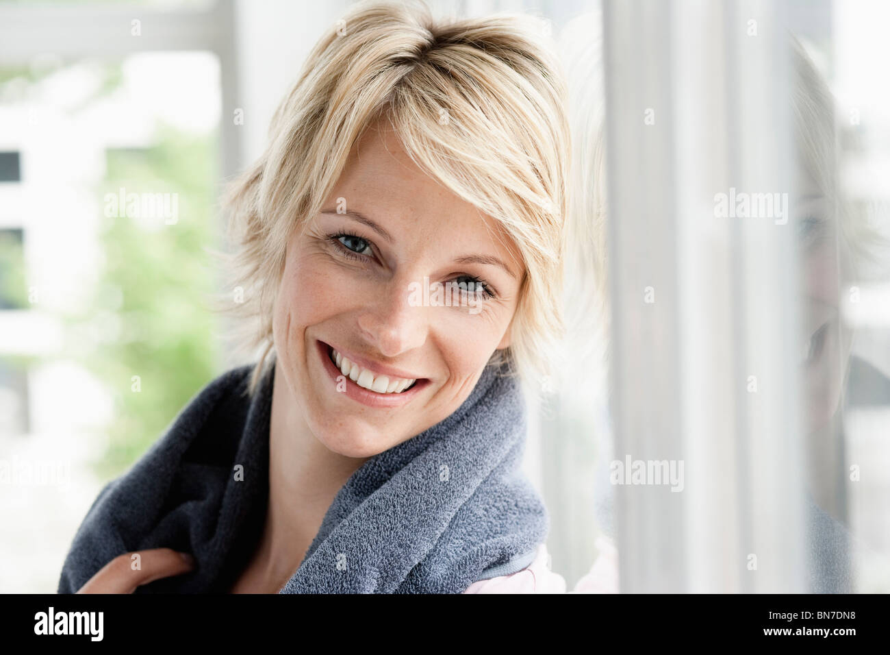 Woman smiling to camera Stock Photo - Alamy