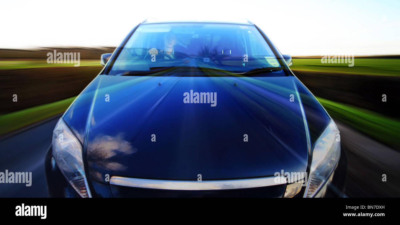 Head on view of a man driving a car made to look translucent Stock ...