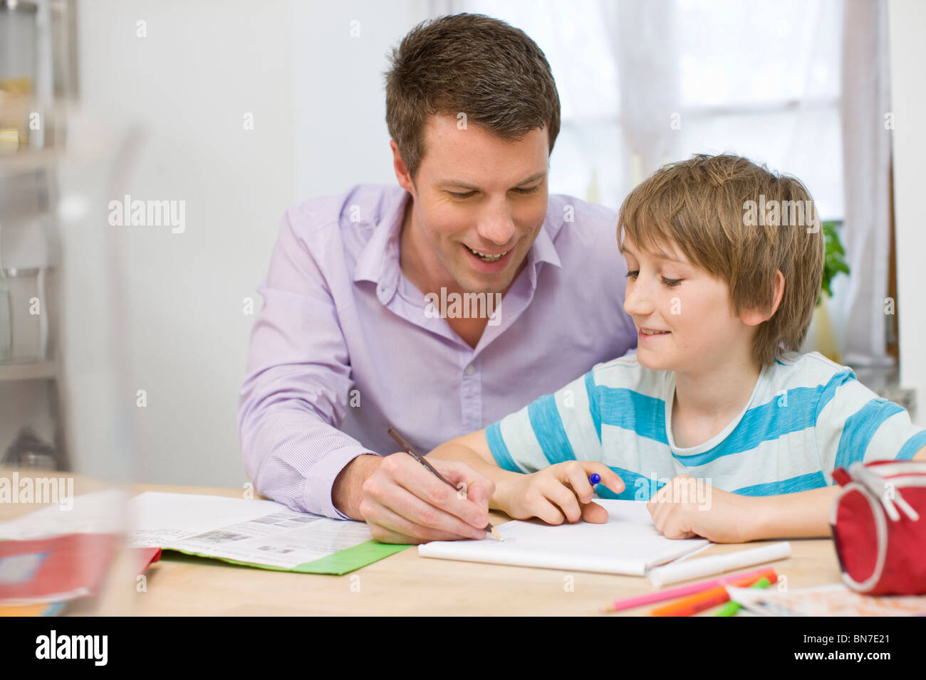 Father and son doing homework Stock Photo - Alamy