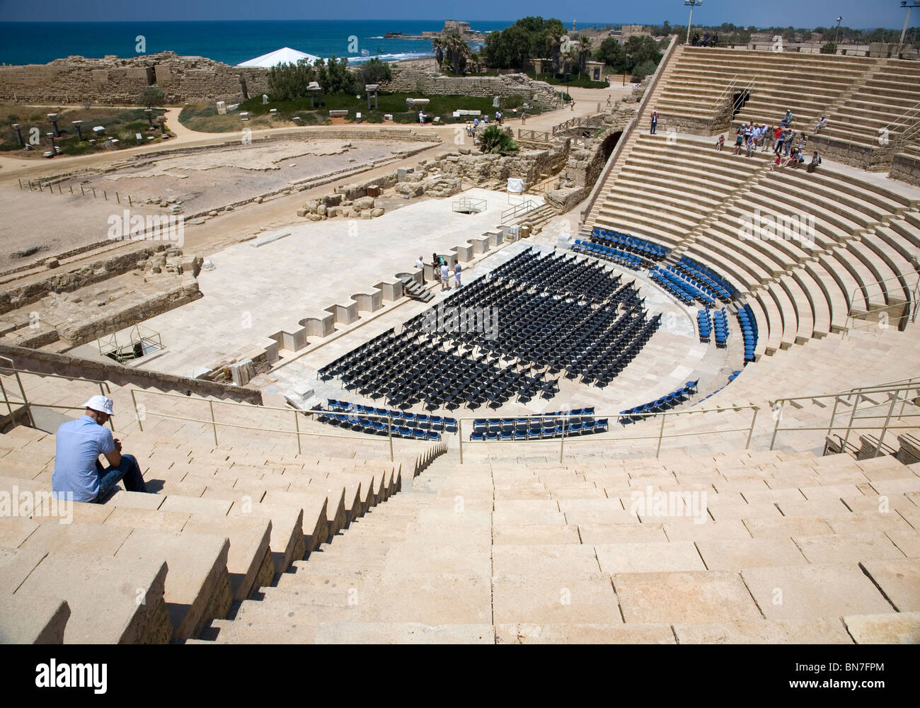 Man sitting in the amphitheater at Caesarea National Park Stock Photo ...