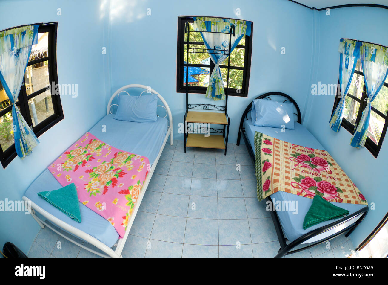 Blue bedroom with two single beds Stock Photo - Alamy