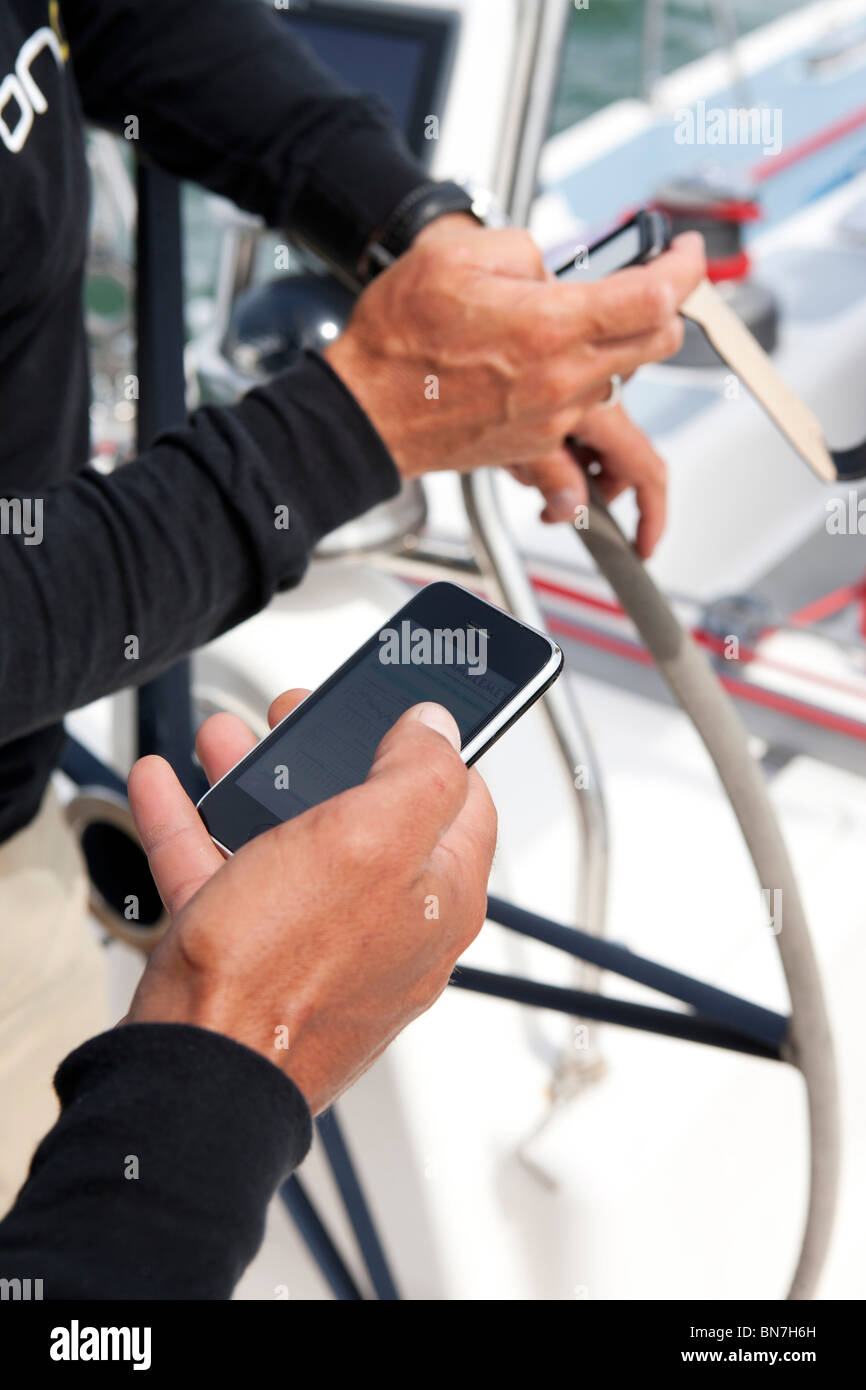 yachtsmen using apple iphone for navigation while sailing in the solent ...