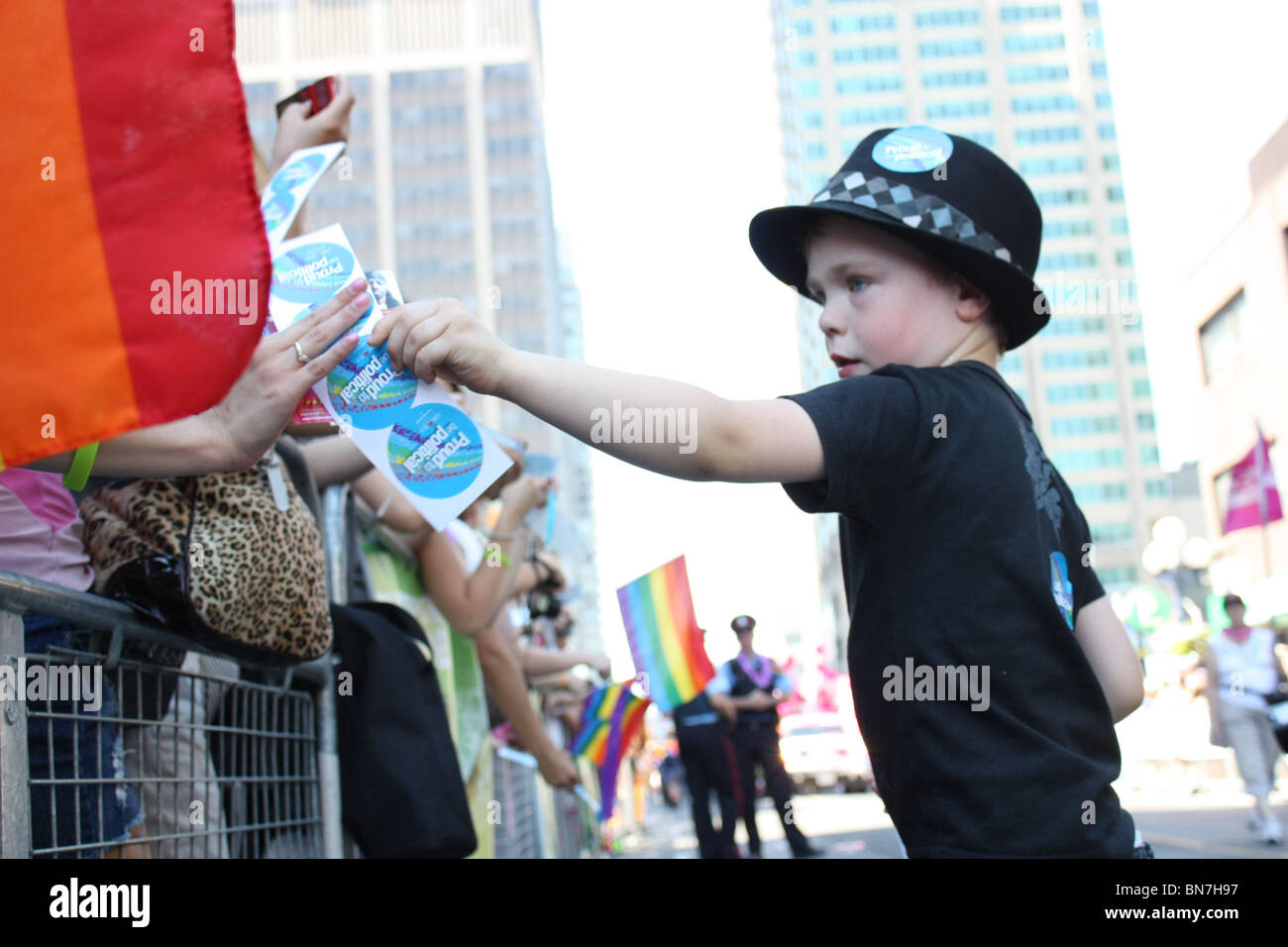 young boy handing sticker street Stock Photo - Alamy