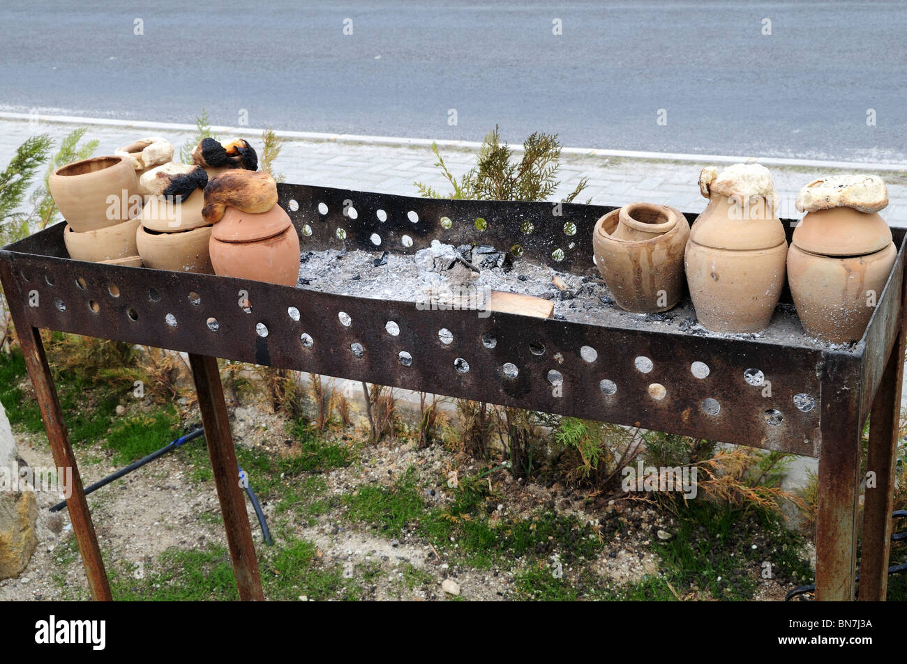 Traditional Turkish meal cooked in a clay pot over charcoal with a ...