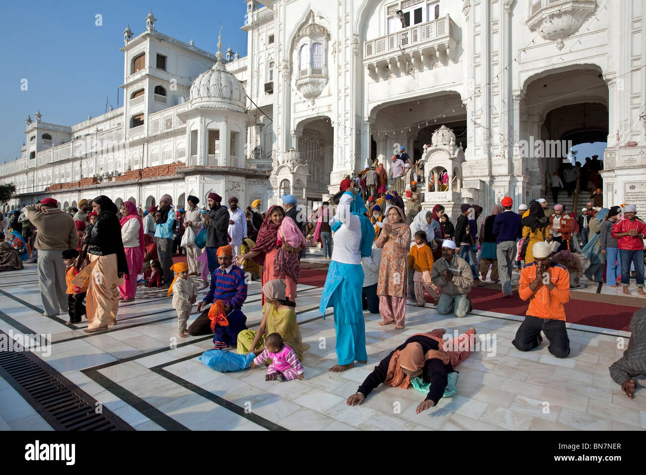 Sikh pilgrims prostrating in front of the Golden Temple. Amritsar ...