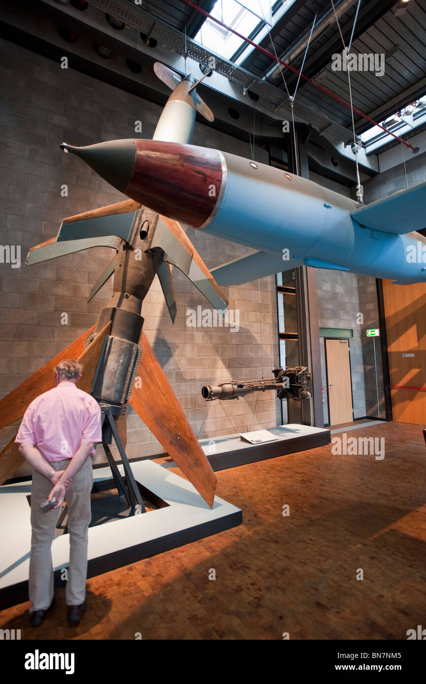 Visitor looking at display of early military rockets at Deutsches ...
