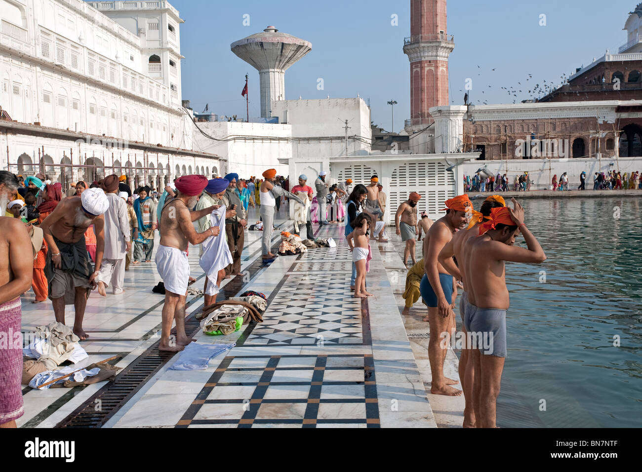 Sikh pilgrims bathing in the sacred pool. The Golden Temple. Amritsar ...