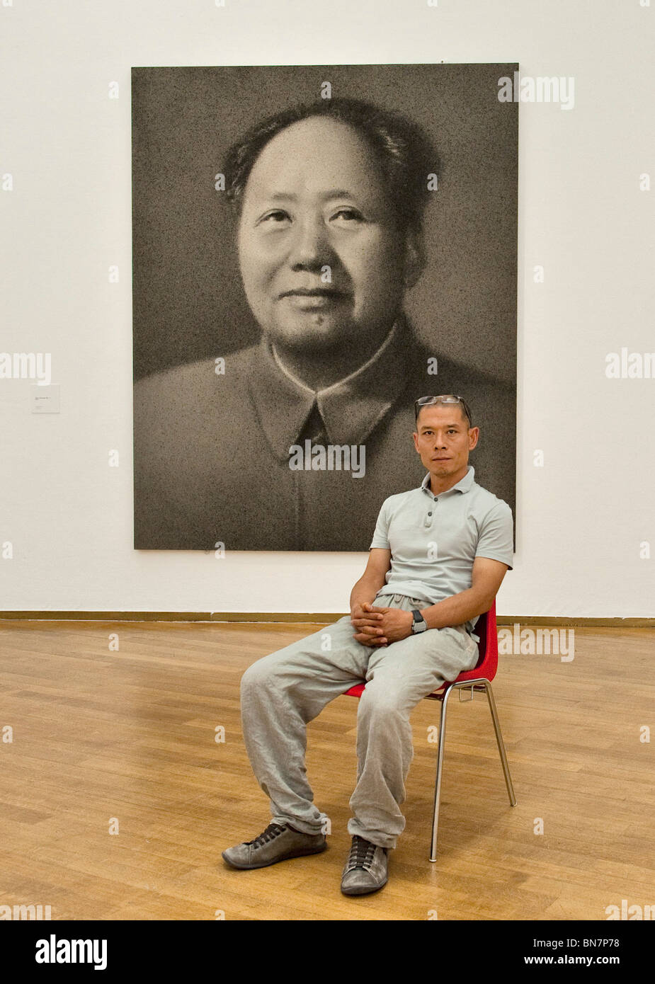 Chinese artist Zhang Huan posing in front of his ash painting " Mao ...