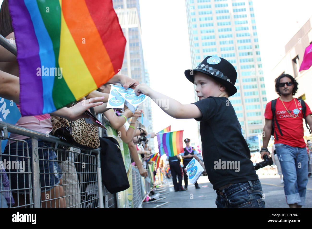 young boy handing sticker street Stock Photo - Alamy