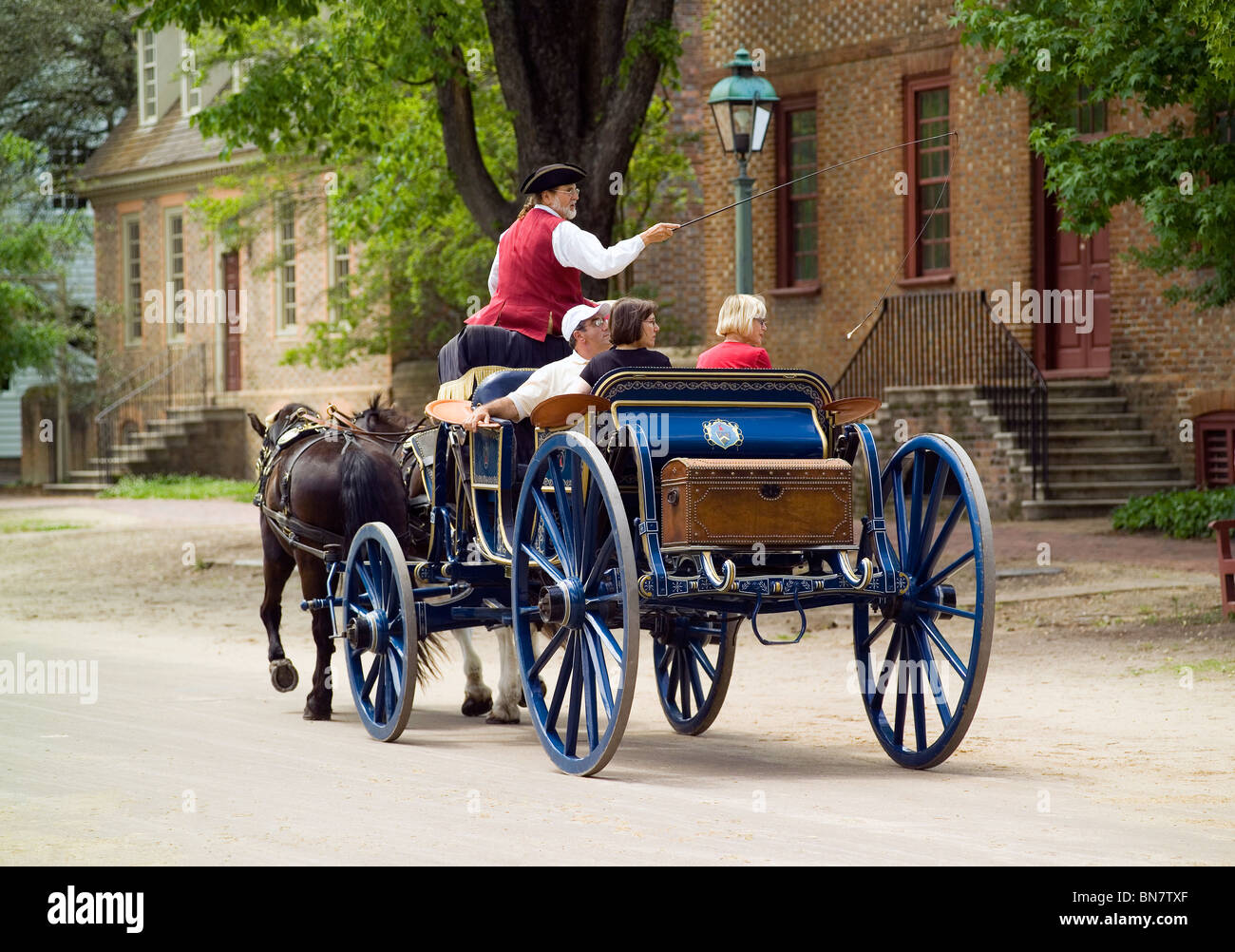 Tourists enjoy a horse-drawn carriage ride through the streets of ...