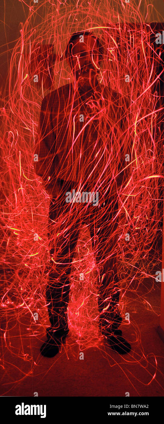 Man standing while being eaten alive by red fire sparks inferno Stock ...