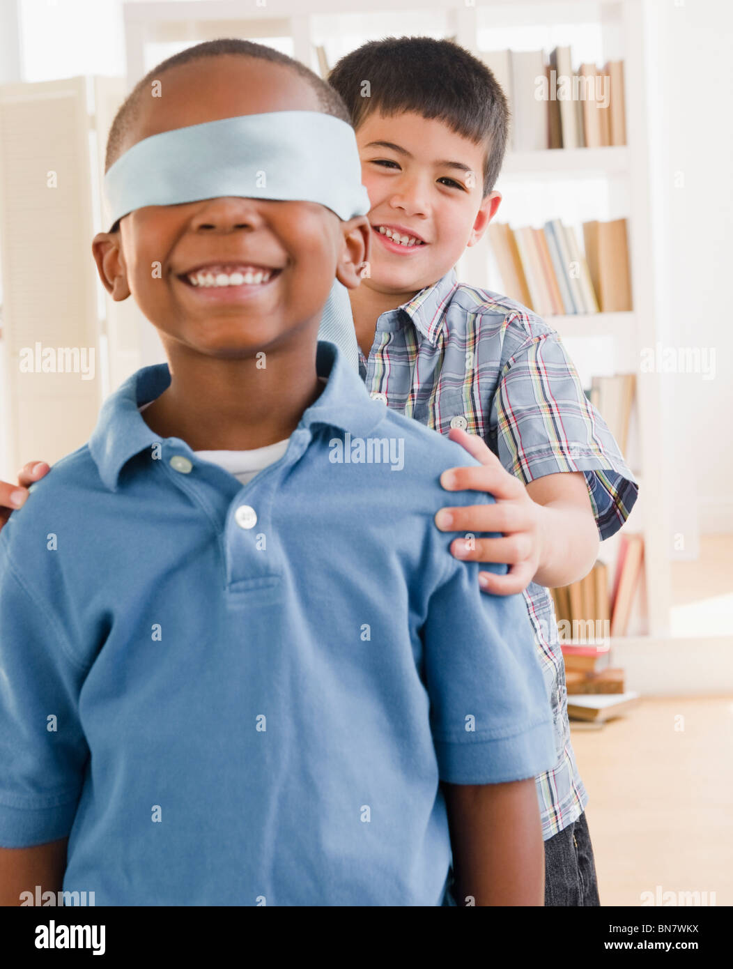 Boy spinning friend wearing blindfold Stock Photo - Alamy