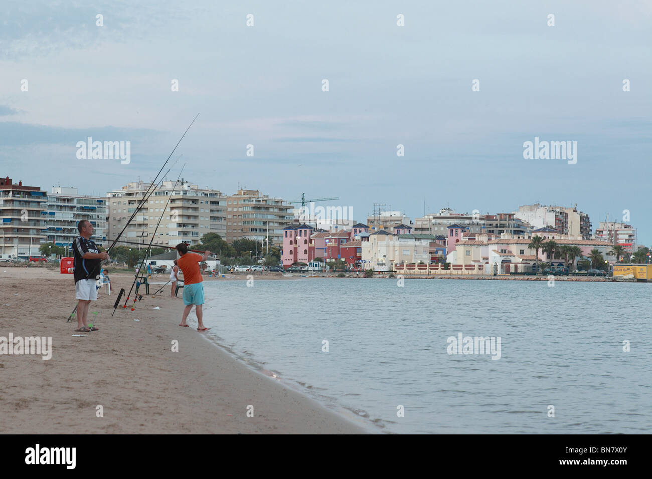 Men Fishing on Spanish Beach Stock Photo - Alamy