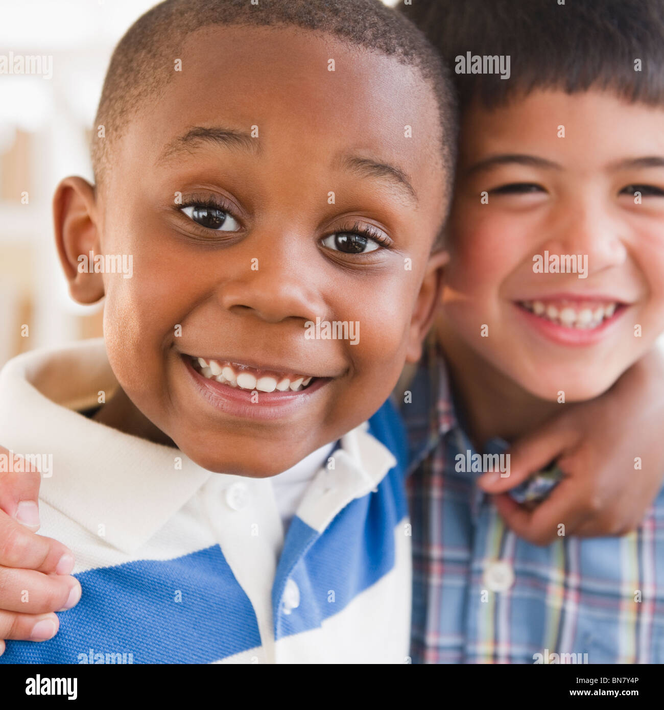 Friends smiling and hugging each other Stock Photo - Alamy