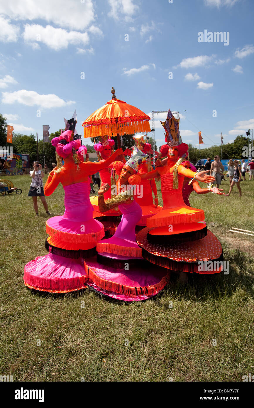 Bright orange cabaret performers in the circus field at the Glastonbury ...